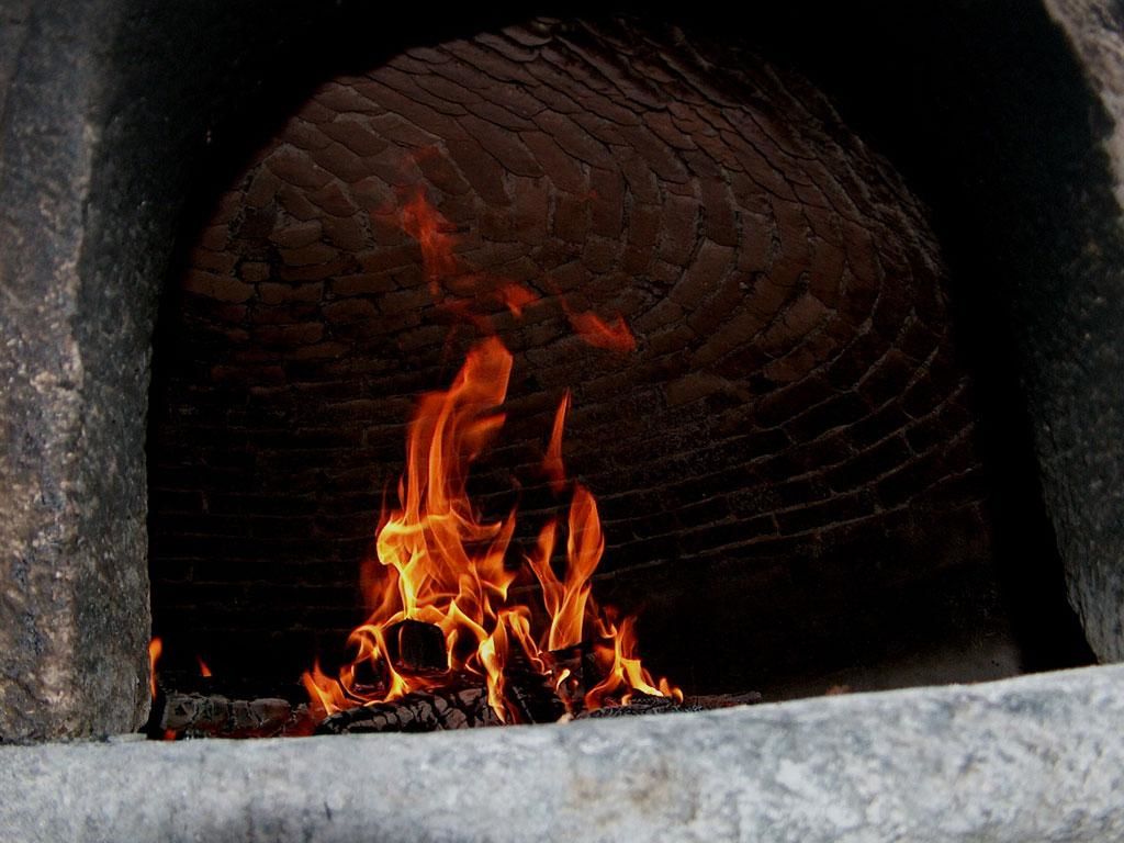 Christmas market and baking of farina bóna bread in a wood-fired oven ...